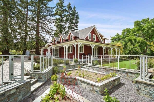 Step into this beyond stunning red farmhouse home in Northern California