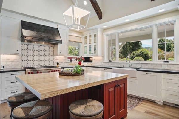 Step into this beyond stunning red farmhouse home in Northern California