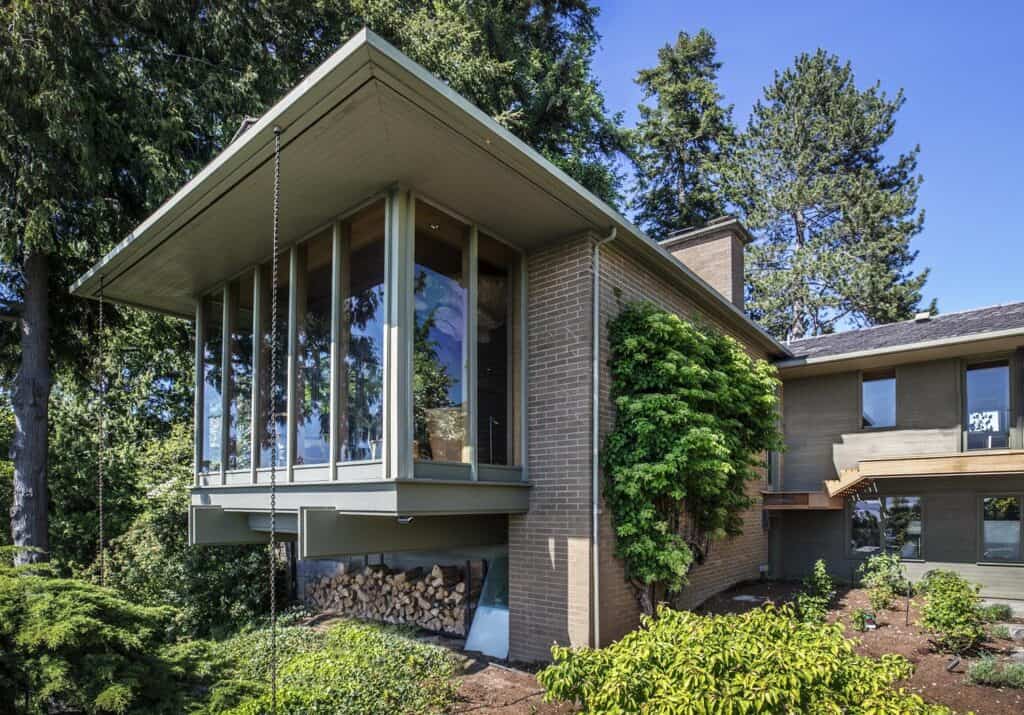 Treehouse inspired midcentury home perched on a cliffside above Puget Sound