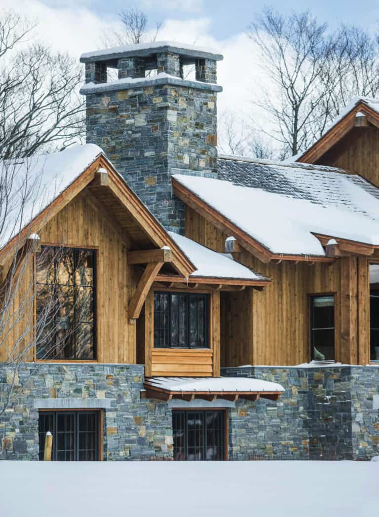 Handcrafted family home in Vermont with a backdrop of snowy peaks