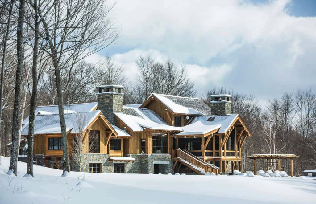 Handcrafted family home in Vermont with a backdrop of snowy peaks