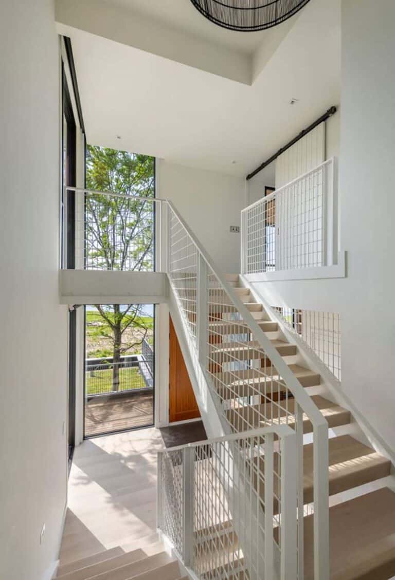 Galvanized steel home offers a woodland escape on the Annisquam River