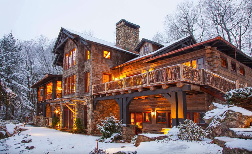 A beautiful Adirondack lodge in New Hampshire with a snowy backdrop