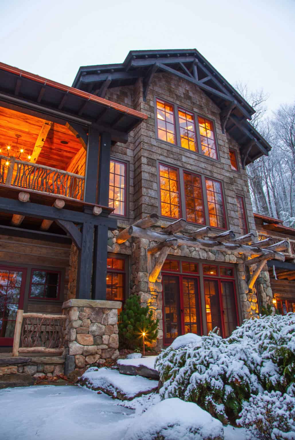 A beautiful Adirondack lodge in New Hampshire with a snowy backdrop