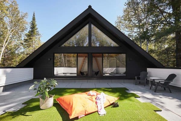 Black charred cedar creates a bold look for this Quebec lake house