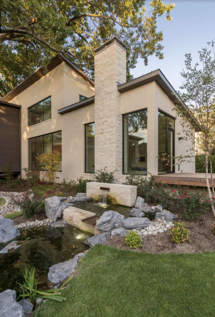 This striking Dallas home features a glass bridge over a serene landscape