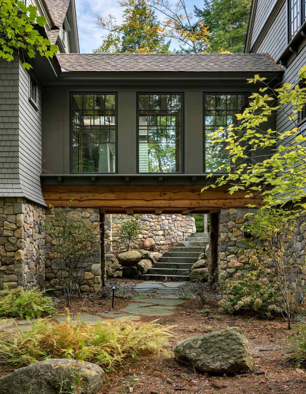 This forest house finds refuge along the serene shores of a New ...