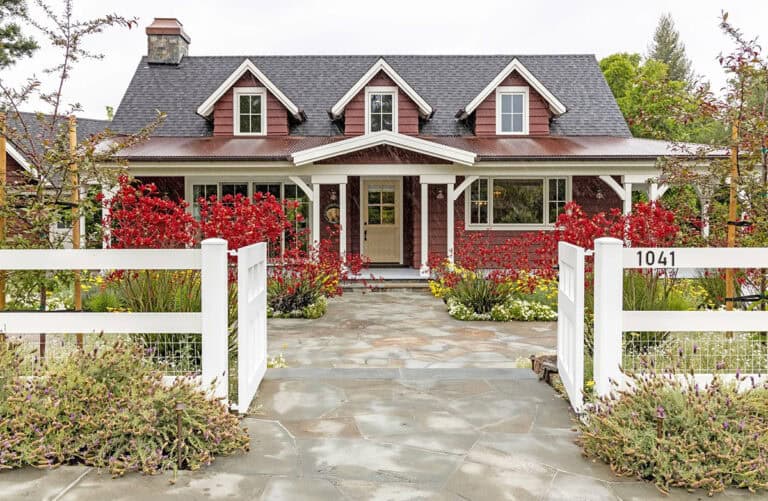 Step into this beyond stunning red farmhouse home in Northern California