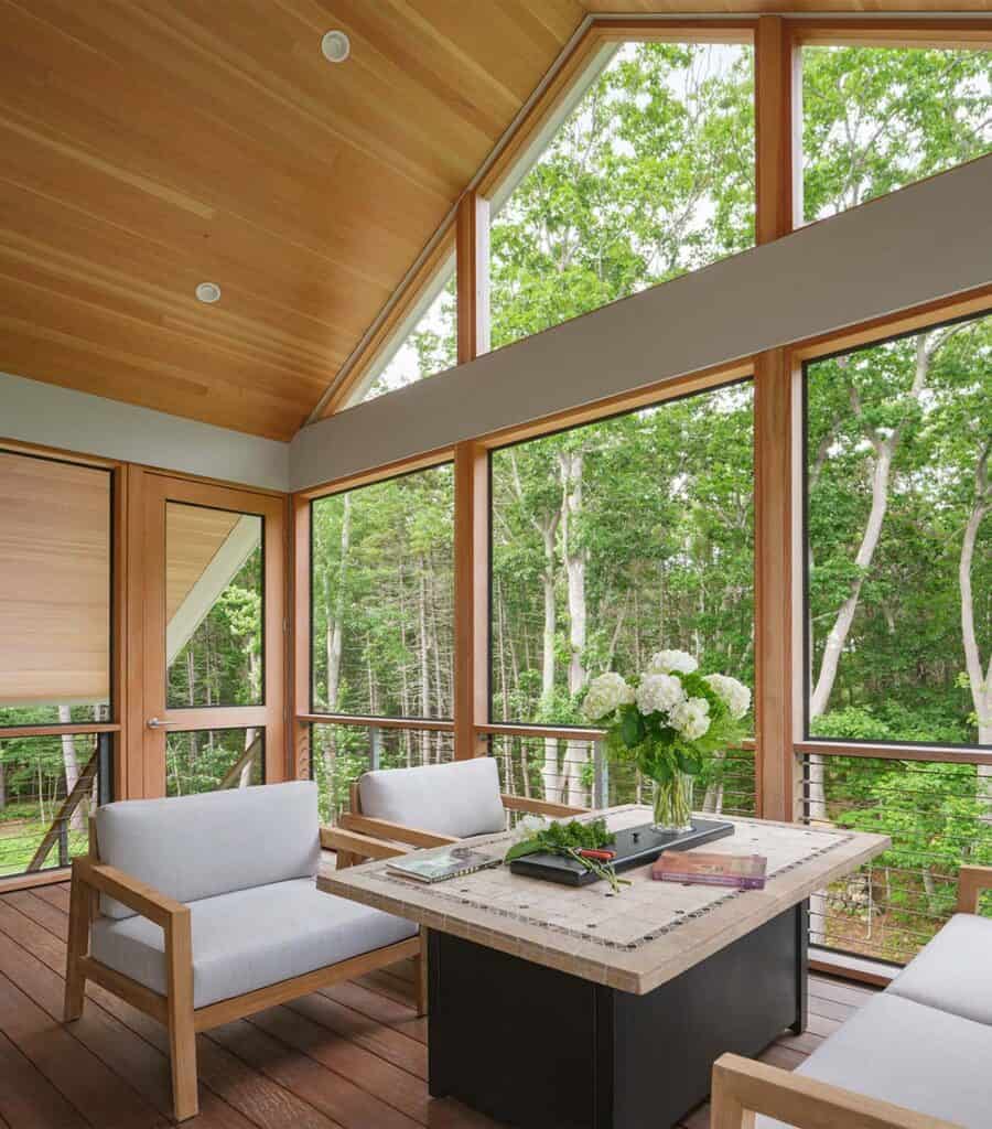 This breathtaking modern Maine home floats above the forest canopy