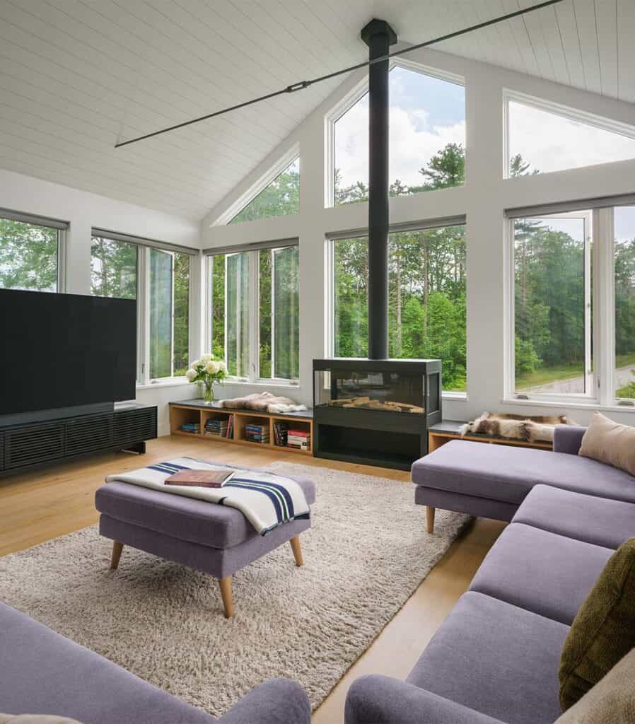 This breathtaking modern Maine home floats above the forest canopy